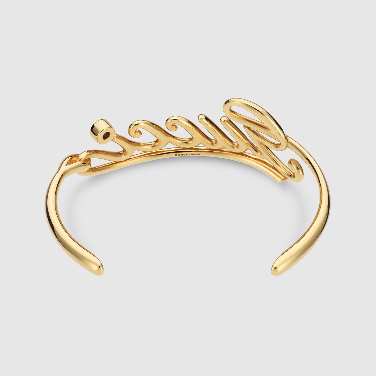 Cuff bracelet with Gucci script in yellow gold-toned metal | GUCCI® US