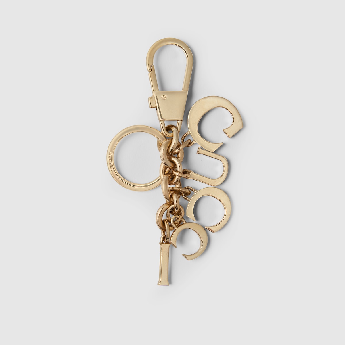 Gucci script keychain in light gold-toned metal | GUCCI® CA