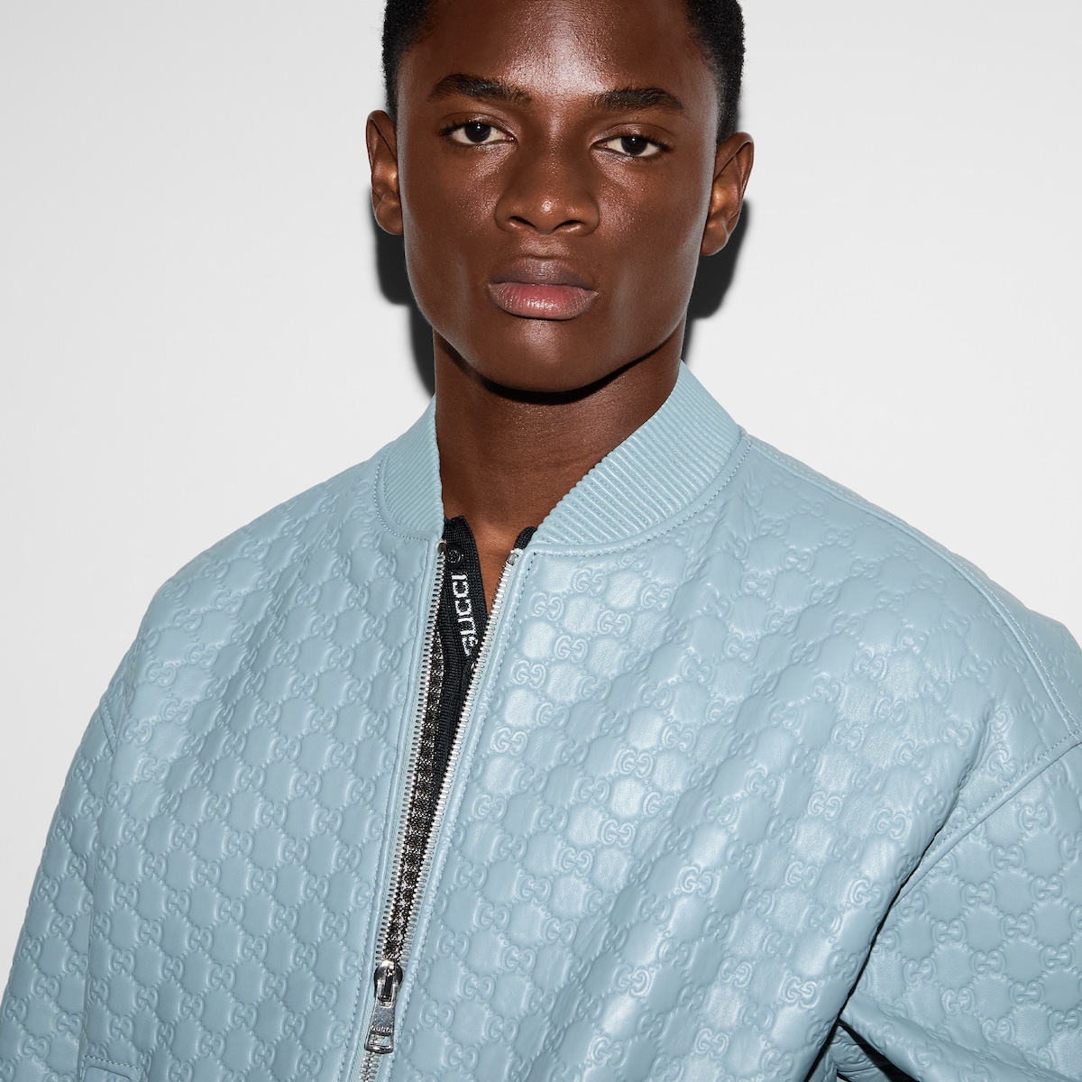 Embossed GG leather bomber jacket in light blue | GUCCI® TR