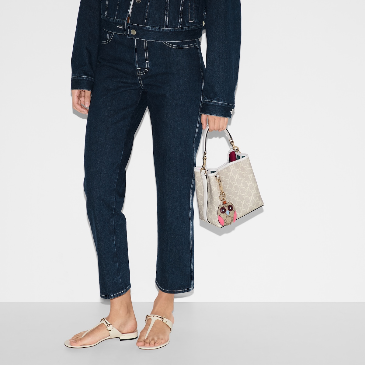 GG Emblem small bucket bag in beige and white GG fabric | GUCCI® US