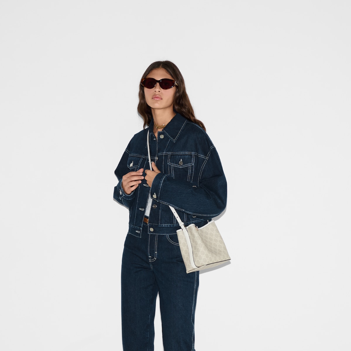 GG Emblem small bucket bag in beige and white GG fabric | GUCCI® US
