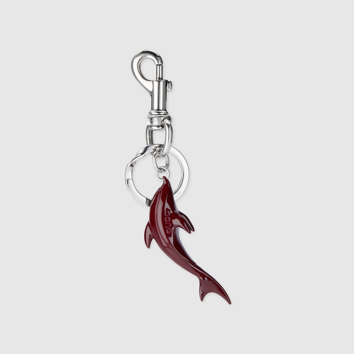 Engraved dolphin keychain charm in rosso ancora red metal | GUCCI® SG