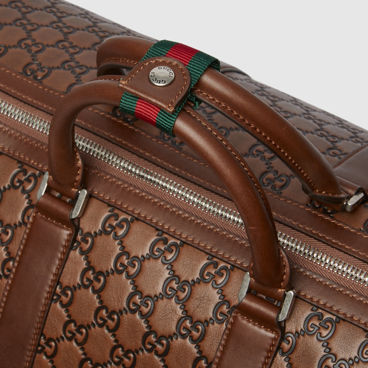 GG Emblem medium duffle bag in brown and black GG leather | GUCCI® CH