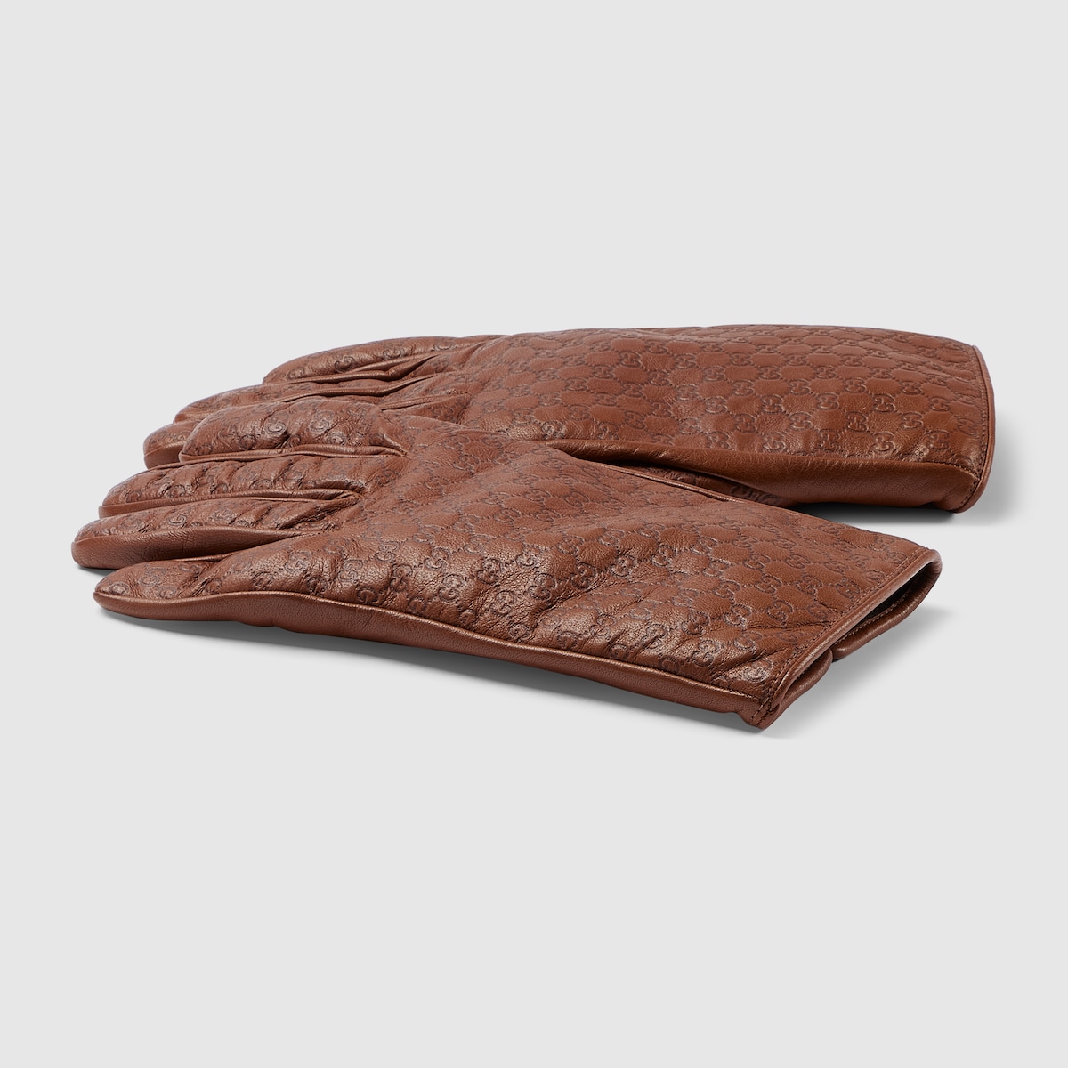 Embossed GG leather gloves in brown | GUCCI® AE
