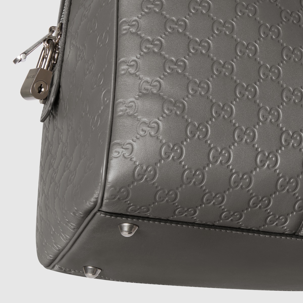 GG Emblem medium duffle bag in grey GG leather | GUCCI® US