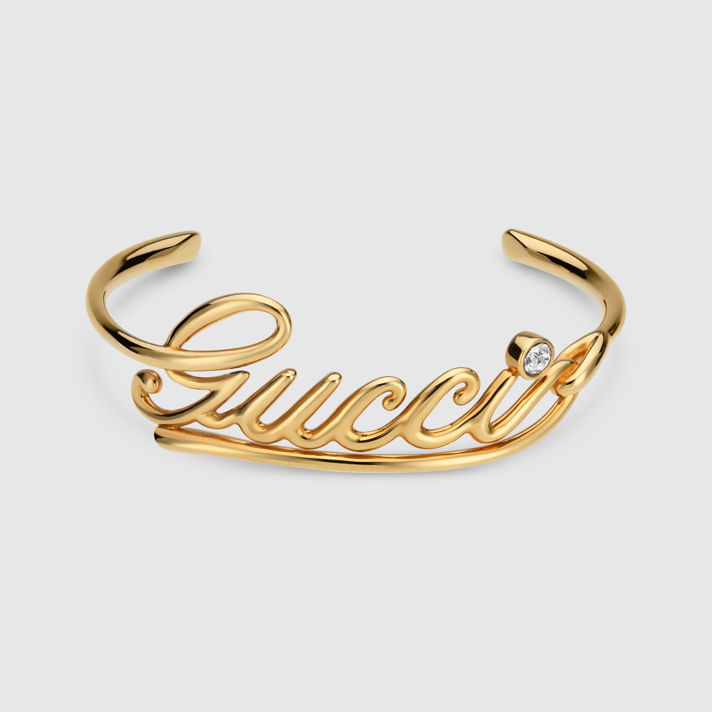 Cuff bracelet with Gucci script in yellow gold-toned metal | GUCCI® US
