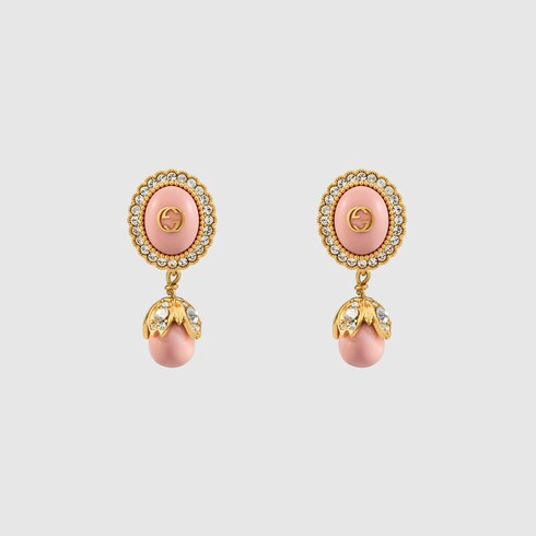 Interlocking G pearl earrings in antique gold-toned metal | GUCCI® AE