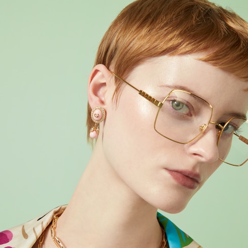 Interlocking G pearl earrings in antique gold-toned metal | GUCCI ...