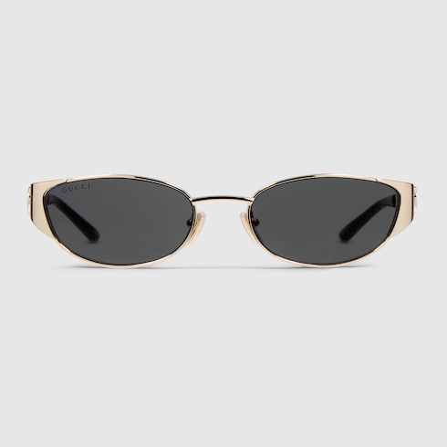 Gafas de sol con montura ovalada en tono dorado | GUCCI® ES
