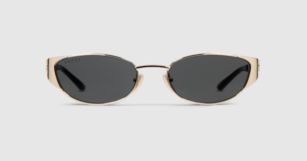Gafas de sol con montura ovalada en tono dorado | GUCCI® ES