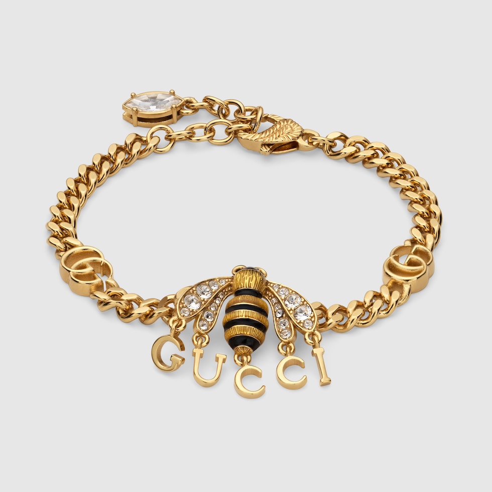 Bracelet with bee pendant and Gucci script in gold-toned metal | GUCCI® NL