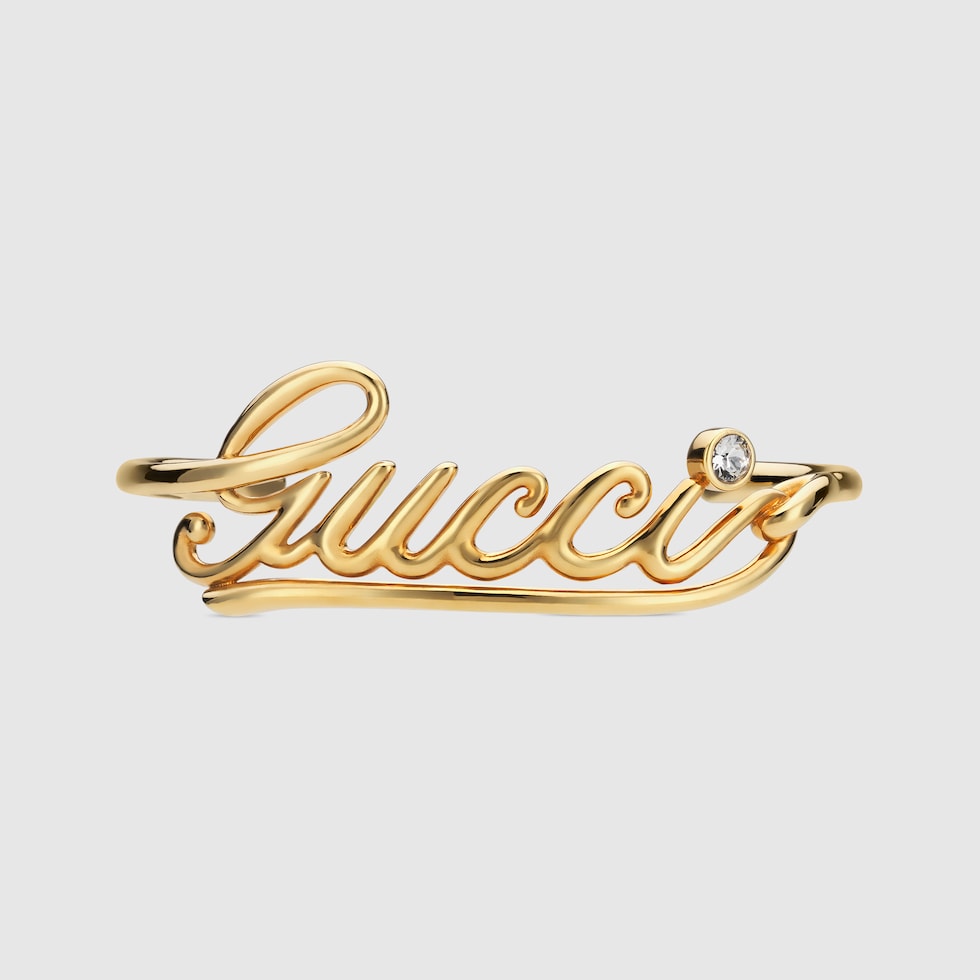 Cuff bracelet with Gucci script in yellow gold-toned metal | GUCCI® US