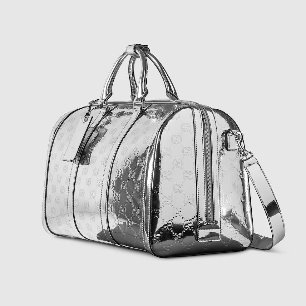 Medium embossed GG duffle bag in metallic silver fabric | GUCCI® UK