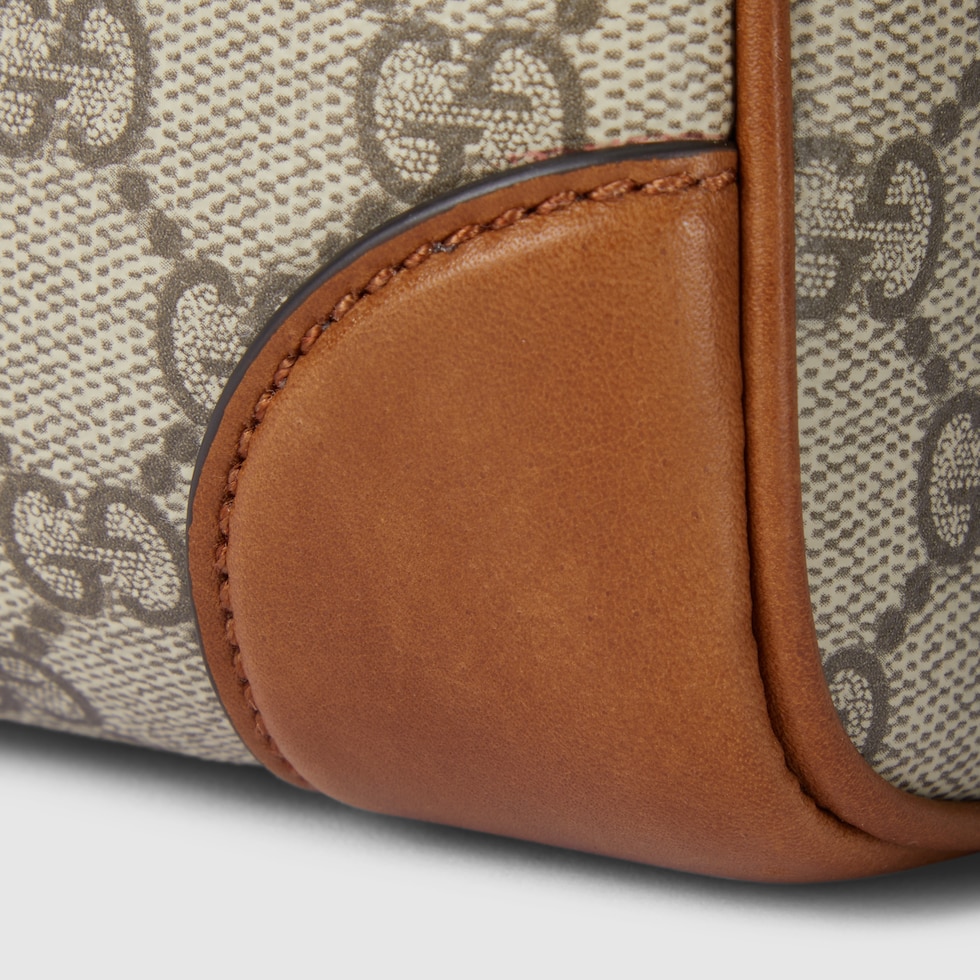 GG Emblem medium toiletry case in beige and dark brown fabric | GUCCI® AE
