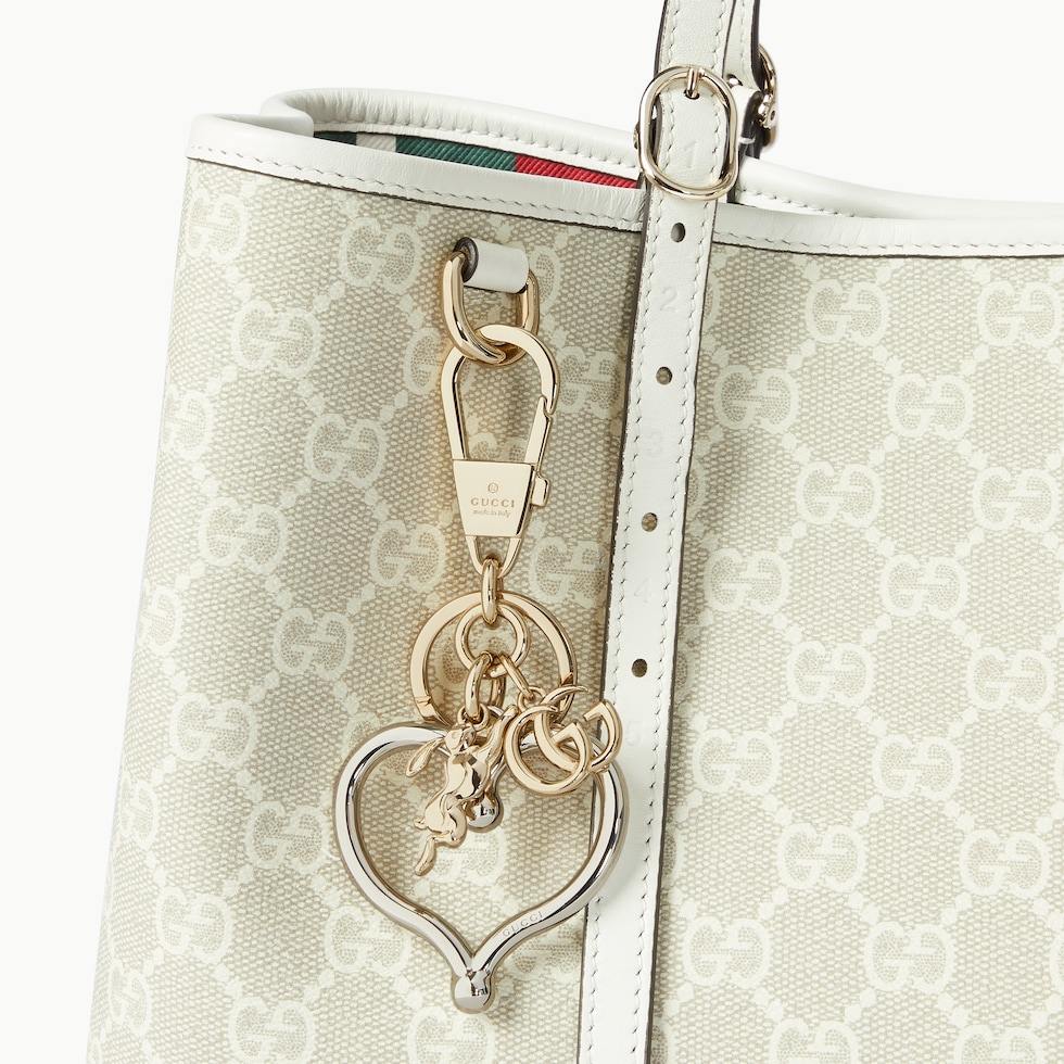 Heart-shaped keychain in light gold-toned metal | GUCCI® NZ
