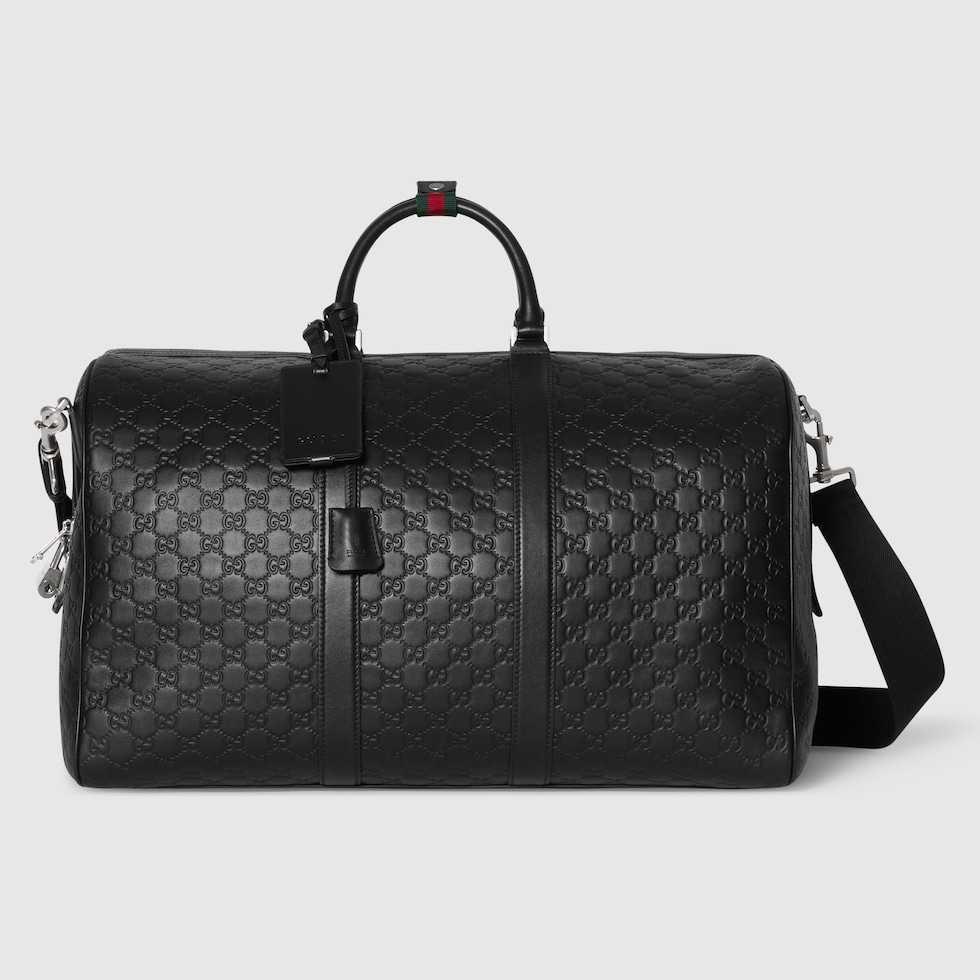 GG Emblem large duffle bag in black GG leather | GUCCI® US