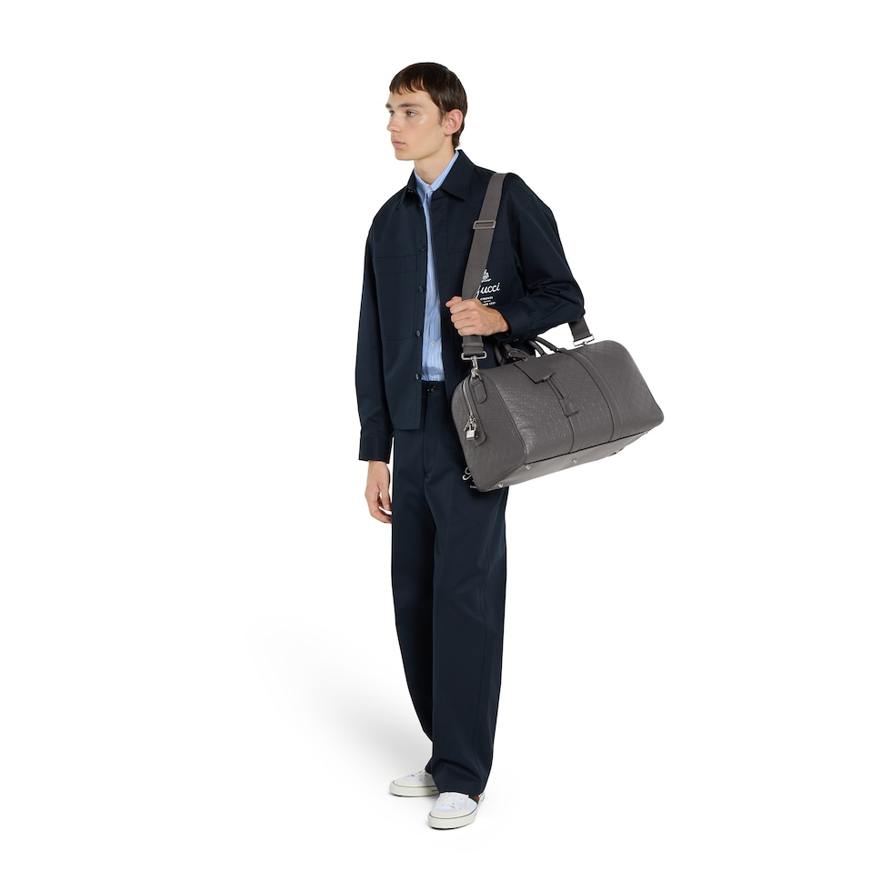 GG Emblem medium duffle bag in grey GG leather | GUCCI® US