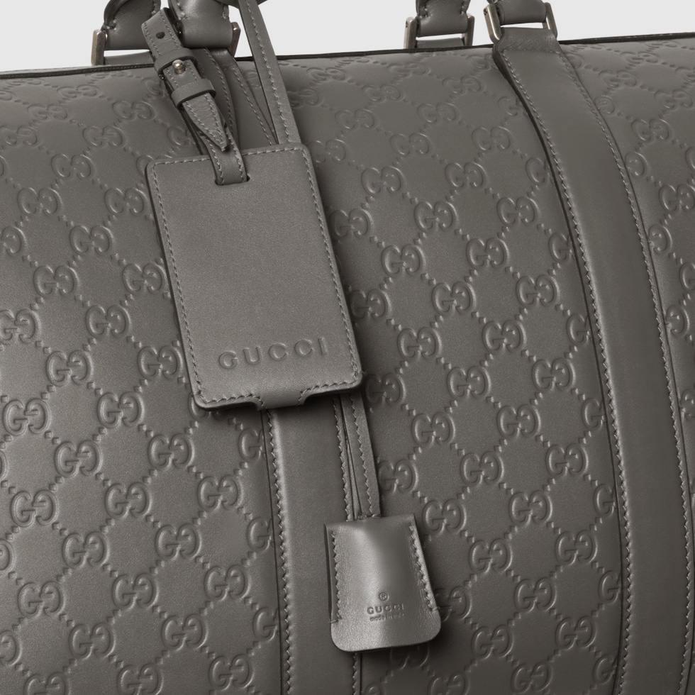 GG Emblem medium duffle bag in grey GG leather | GUCCI® US