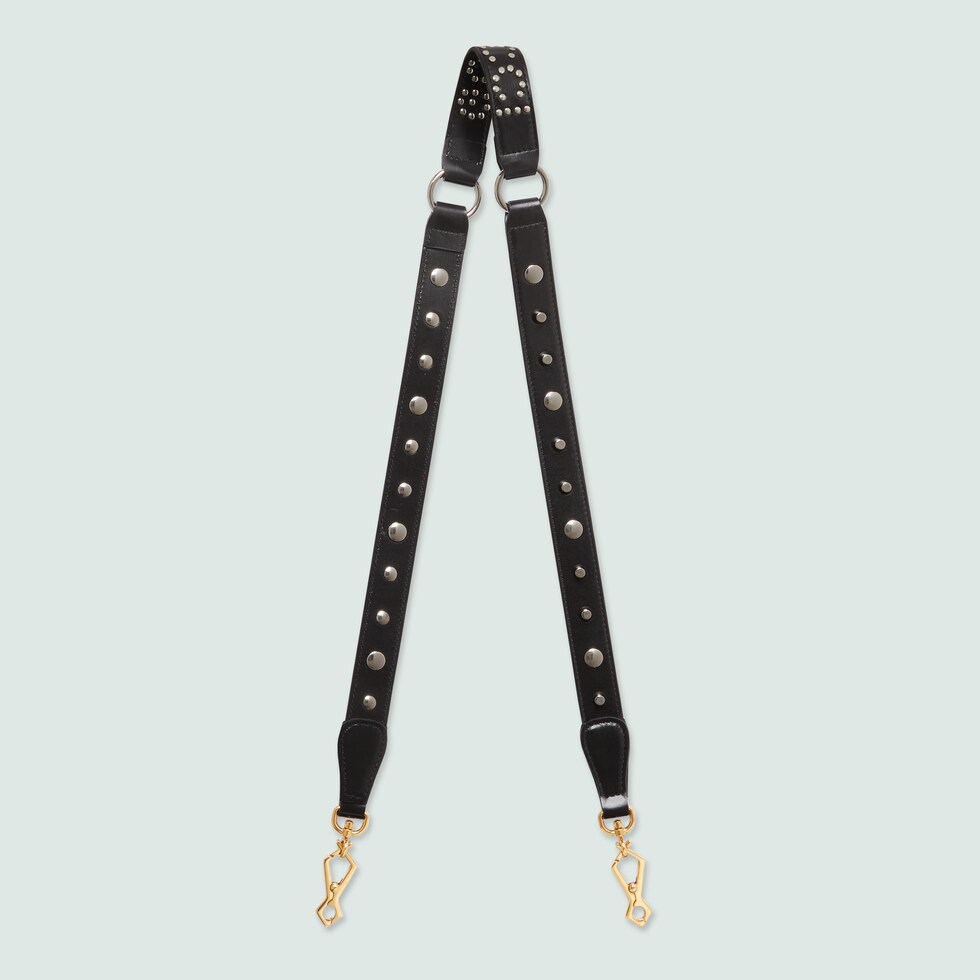 Thin studded 'Gucci' shoulder strap in black leather | GUCCI® AE